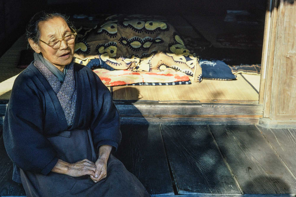 Woman Sitting in a Doorway, Japan – Jay Maisel