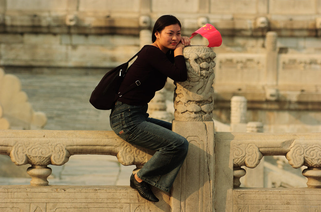 Woman Straddling Stone Rail, Beijing – Jay Maisel